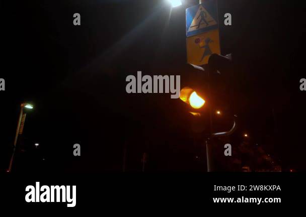Traffic light warning sign at a pedestrian crossing at night. Road ...