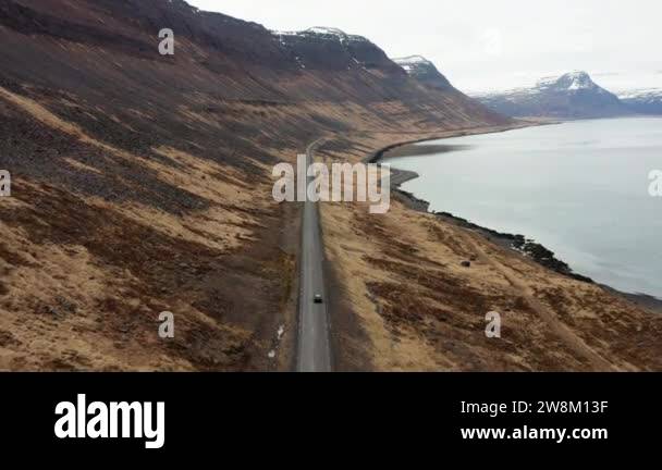 Drone Tracking Car Driving By Fjord And Towards Mountains Stock Video ...