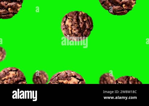 Flying Dark chocolate chip cookie of different diameters on the green ...