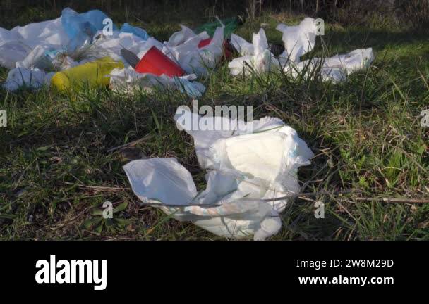 A pile of discarded used baby diapers in nature. Personal hygiene ...
