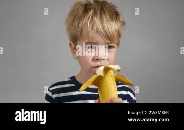 Happy Child Enjoys Eating Tasty Banana. Portrait Cute Little Boy. Glad ...