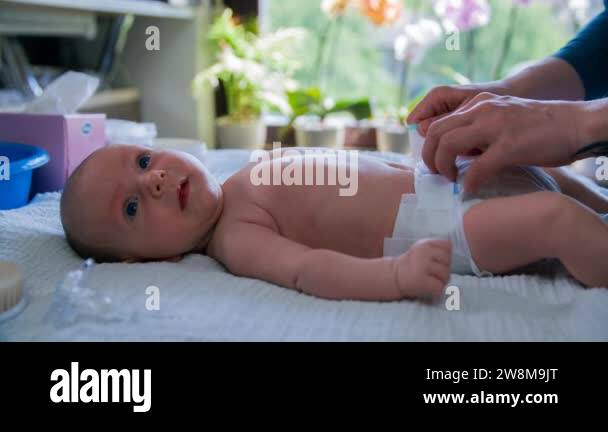 Mother carefully changing her baby's diapers Stock Video Footage - Alamy