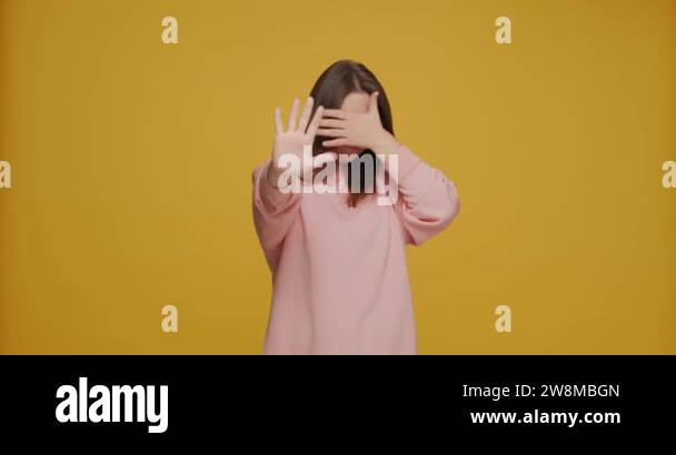Afraid young girl cover eyes with palm showing stop hand gesture dont ...