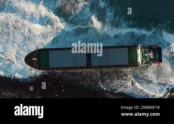 The dry cargo ship washed ashore during a sea storm. Oil spills. An ... The dry cargo ship washed ashore during a sea storm. Oil spills. An ...