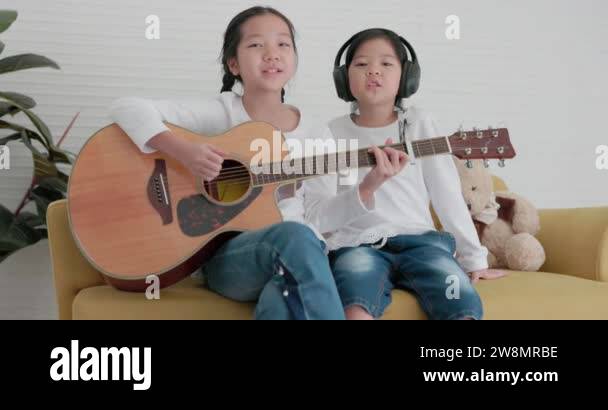 Two sisters are having a fantastic time in the living room. From the ...