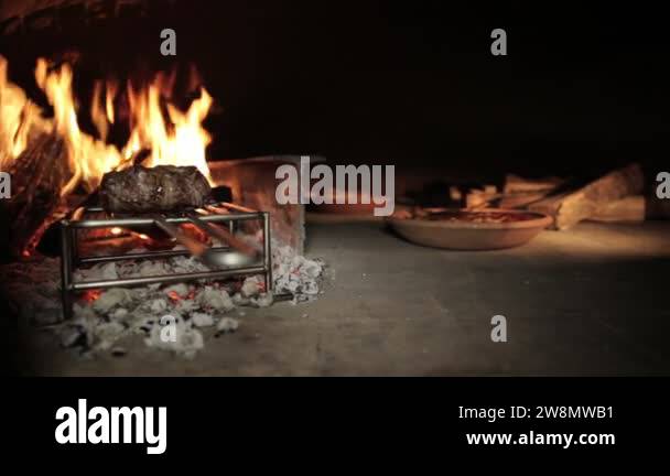 Meat in the oven on fire. Spanish cuisine.A traditional oven with a ...