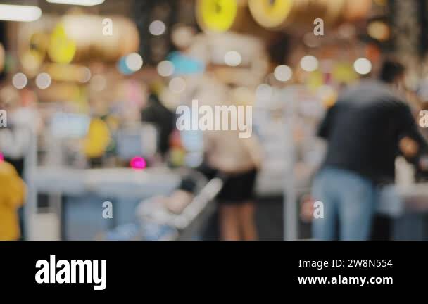 Blurred view unfocused unrecognizable people in store man and woman ...