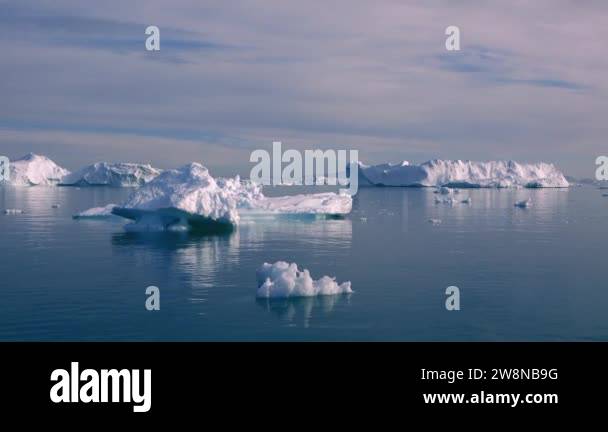 Floating glacial iceberg in frozen ocean water. Ecotourism and cruise travel to the Arctic and ...