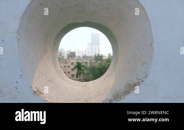 View through a hole in the wall of a newly built construction to the ...