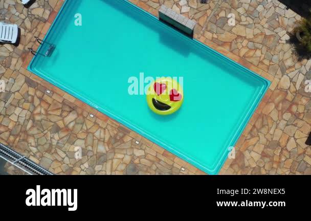 Top view of smile emoji float at swimming pool. Float smile emoji ...