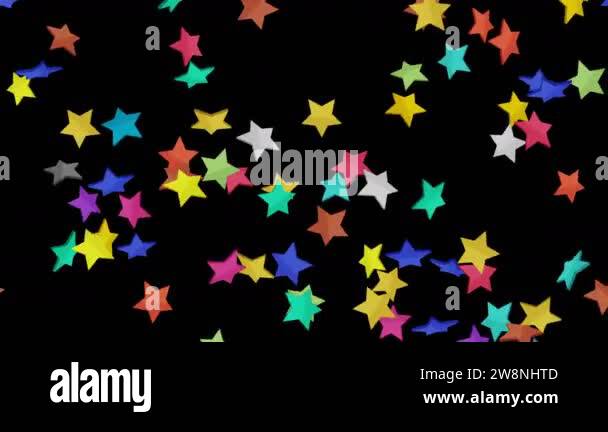 Many colorful stars floating in air on black background. Star icons ...