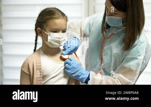 Cute kid patient visiting female doctor pediatrician nurse holding ...