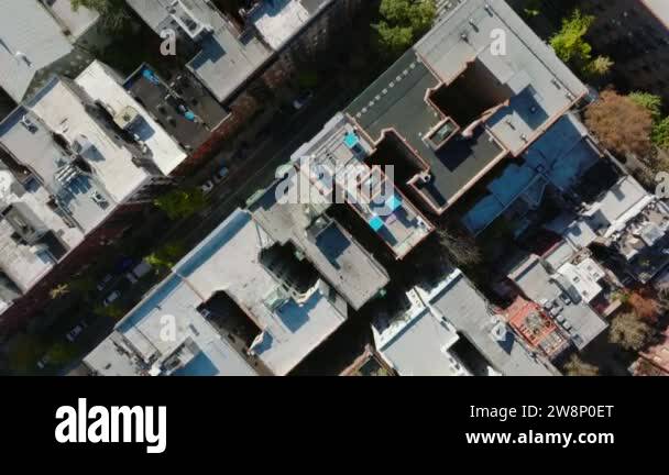 Aerial birds eye overhead top down panning view of blocks of apartment buildings in residential ...