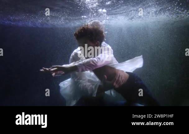 dad is teaching his little son to dive and swim underwater, father and ...