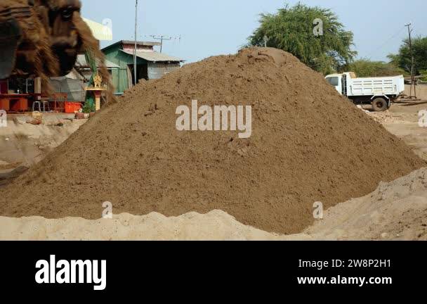 Excavator discharging and piling up sand at disposal site Stock Video ...