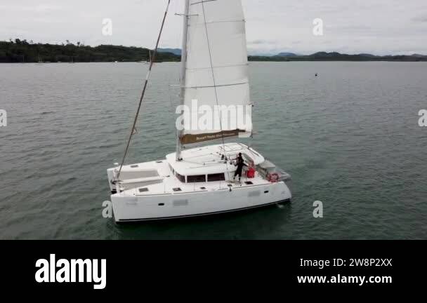 Sailor and captain on turn sailing catamaran in the bay, top view Stock ...