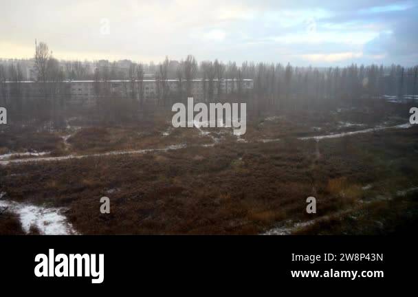 Winter weather outside the window. It is snowing and raining. Blizzard ...