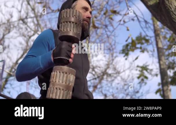 Low Angle Shot Of Strong Grey-Haired Man With Dreadlocks exercising ...