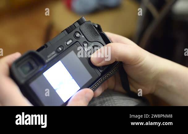 She sets up the camera before shooting. Man turns the wheels of the ...