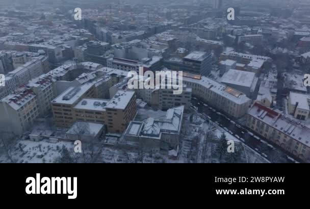 Aerial panoramic footage of snow dusted town development. Hazy winter ...