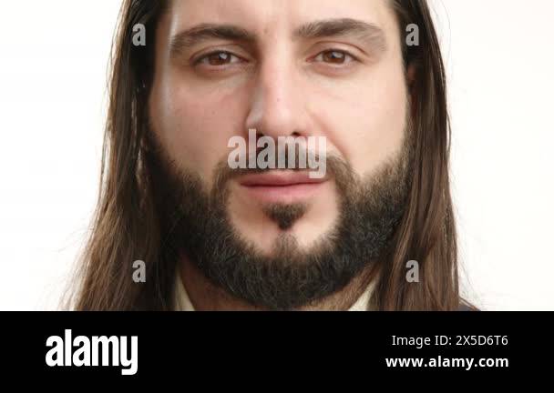 A close-up portrait that captures the subtle, contented smile of a man ...