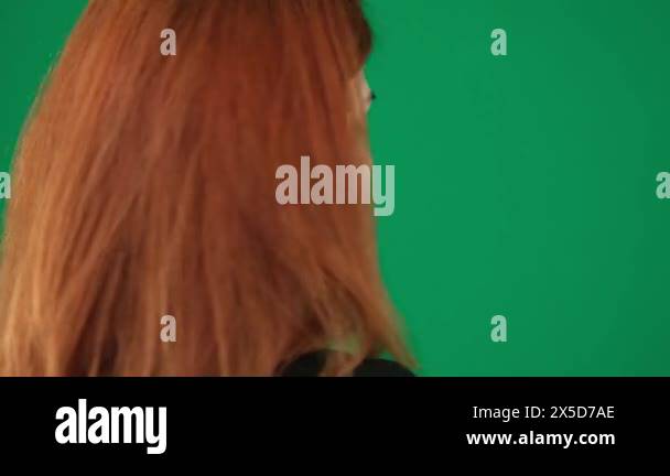A close-up of a red-haired girl turned around in the frame red hair ...