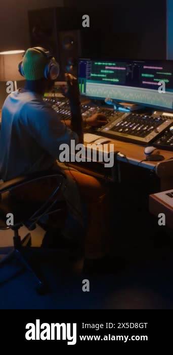 Full vertical of African American male music producer in headphones ...