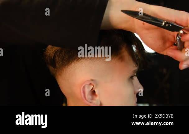 Barber shop. Man in barbers chair, hairdresser prepare his hair with ...