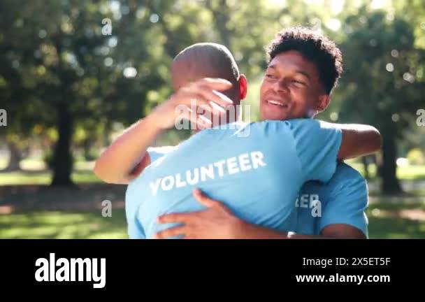 Volunteer, men and hug in park for help, NGO and charity for community ...