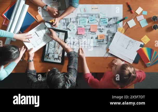 Top down aerial view of civil engineer hold project plan while design ...