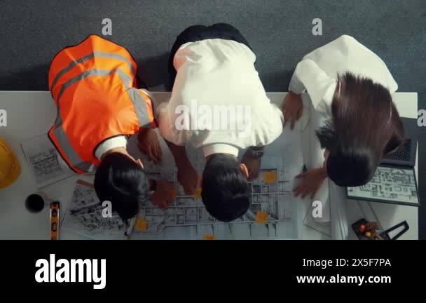 Top view of smart architect and skilled civil engineer team working together to design building ...