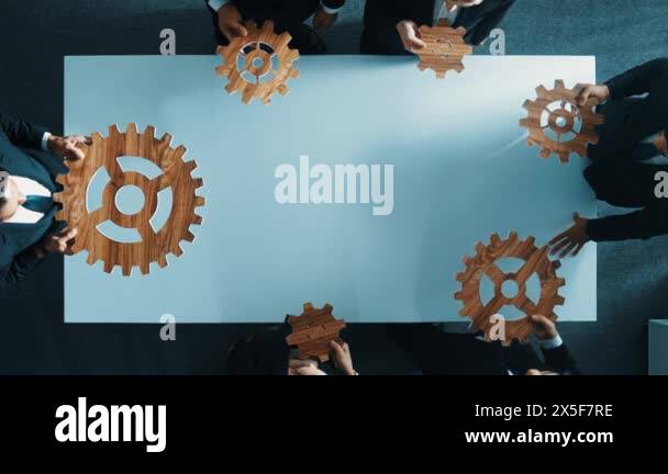 Top view of smart business people gather wooden cog together at meeting ...