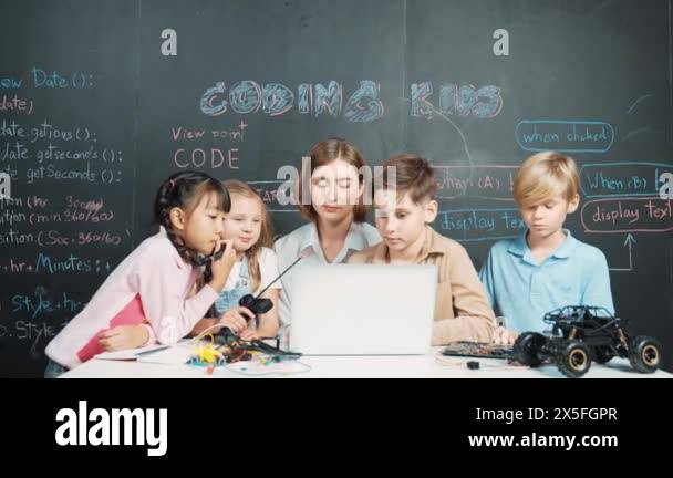 Smart teacher and diverse student looking at laptop on table with car ...