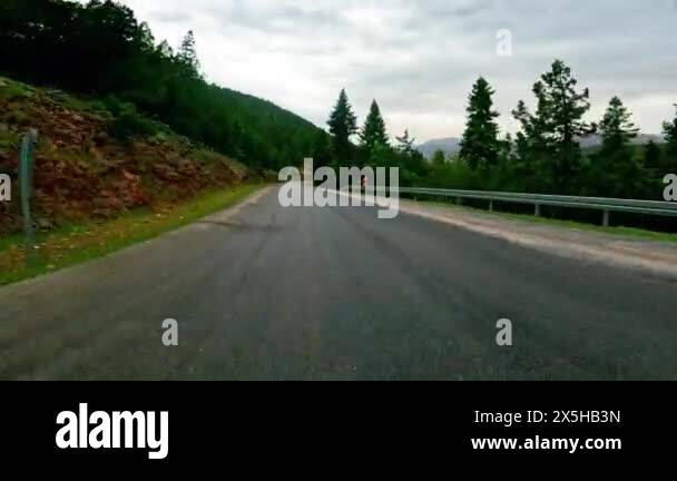 First-person footage of driving, serpentine mountain road. Video shows ...