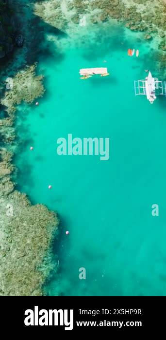 White sand beach and turquoise lagoons with boat and kayak in Miniloc ...
