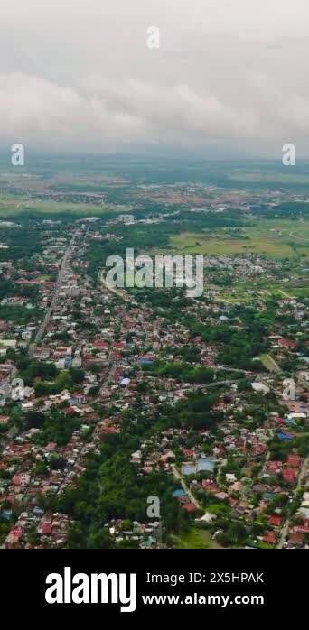 Drone view of Iloilo City with houses and colonial churches. Panay ...