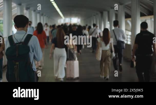 Crowd of people in metropolis city overhead passage walkway activity ...