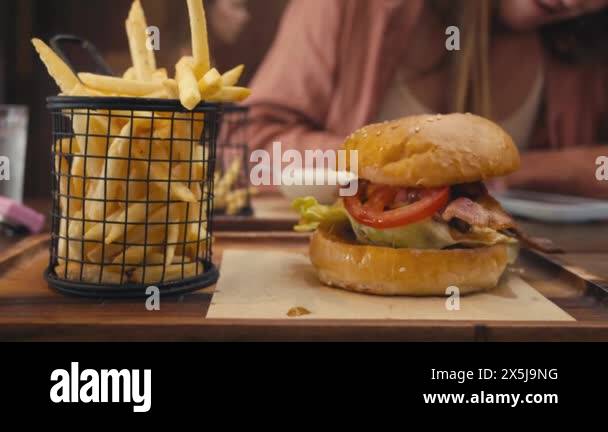 Restaurant close-up fast food juicy burger golden-brown french fries ...