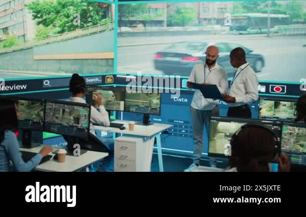 Diverse employees using CCTV surveillance system in monitoring traffic ...