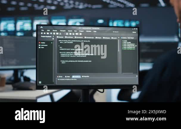 System Administrator Running Script On Computer Screen In High Tech Data Center Ensuring