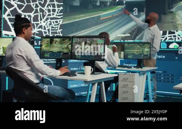 Team of employees monitoring delivery trucks with gps coordinates on ...