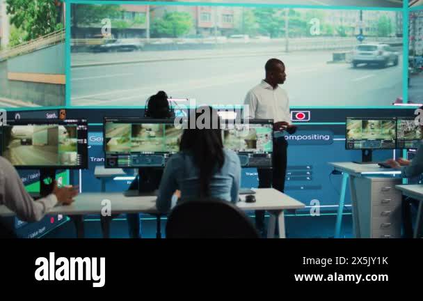 Team leader supervising his employees monitoring the traffic, diverse ...