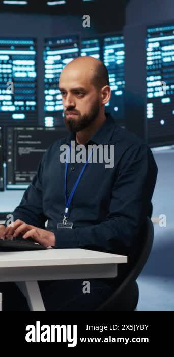 Vertical Video Computer Scientist In Server Farm Coding Ensuring Data Remains Shielded From