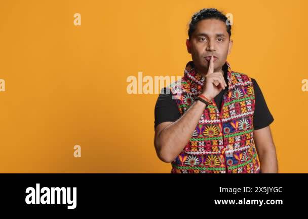 Authoritative man doing shushing hand gesturing, demanding secrecy ...