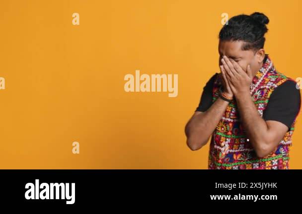 Indian man covering face with palms in disbelief, feeling upset by ...