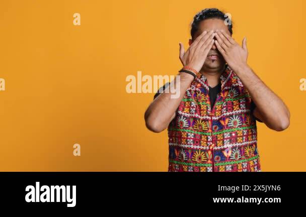 Indian man covering eyes, ears and mouth with hands, imitating the ...