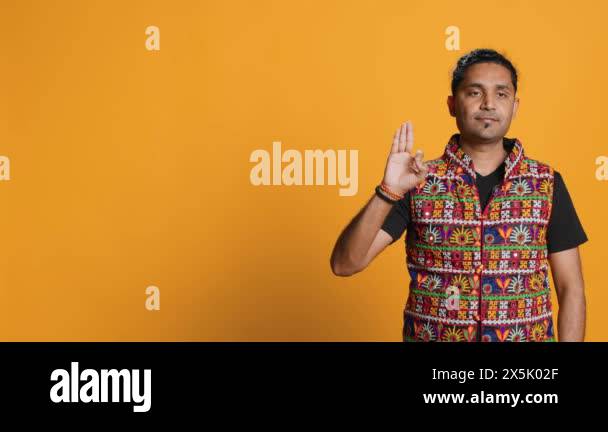 Indian man doing ok hand sign, feeling pleased, agreeing with ...