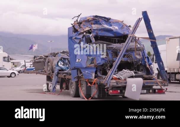 Serious accident, wrecked blue truck on tow truck in parking lot. Flak ...