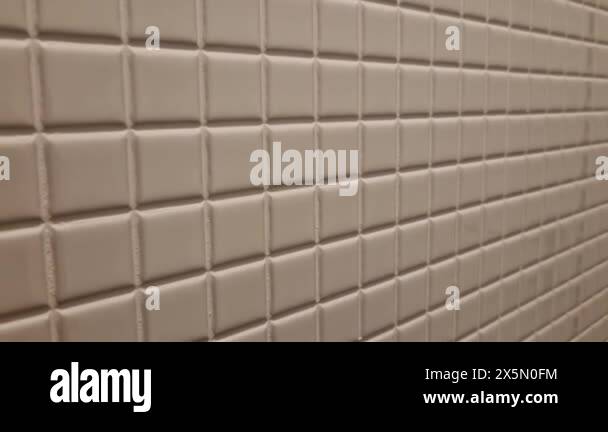 urinal lined with white ceramic tiles square texture mosaic. wall ...