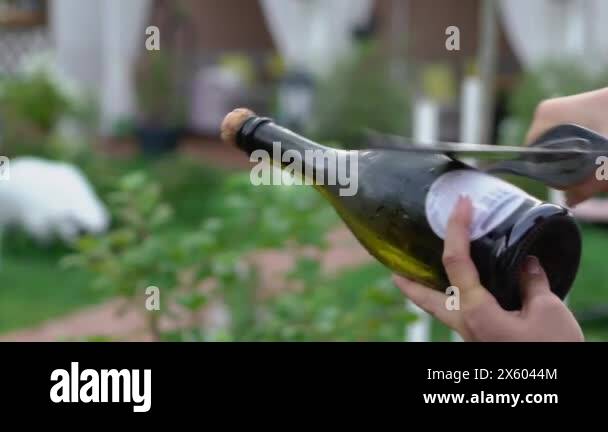 Barman opens bottle of champagne with saber. Traditional sabrage Stock ...